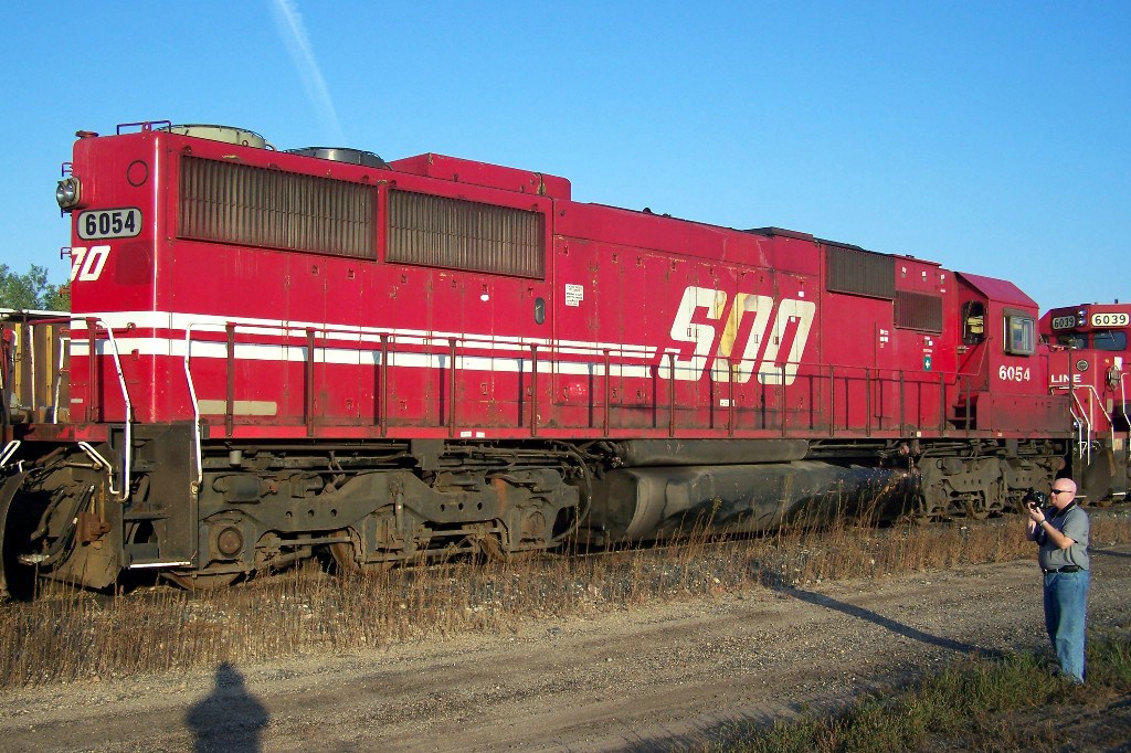 Soo Line Society president Galen Fromm takes a shot of the stored SD60s